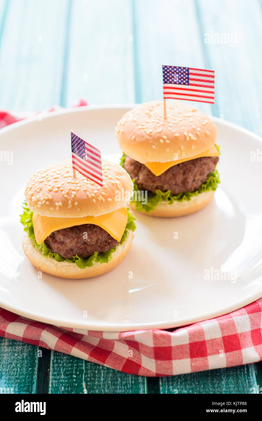 Mini beef burgers with American flag in white plate,selective focus ...