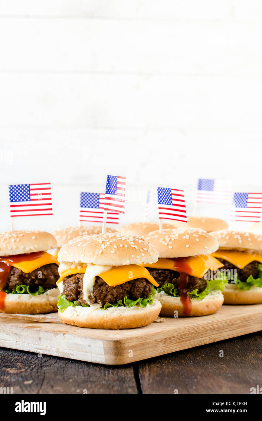 Mini beef burgers with American flag on wooden board,selective focus ...