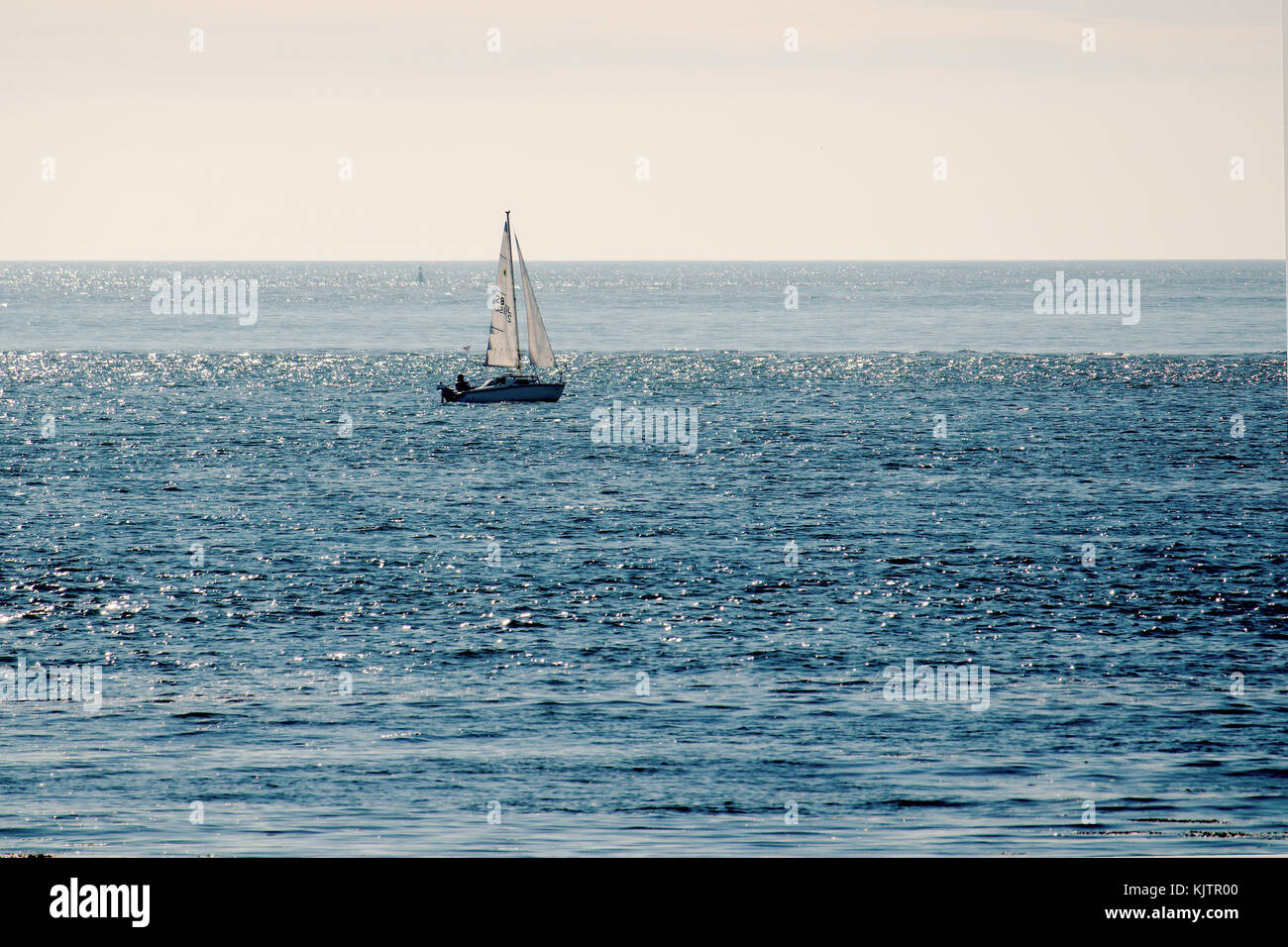 A sailing boat with sails set on the ocean Stock Photo - Alamy