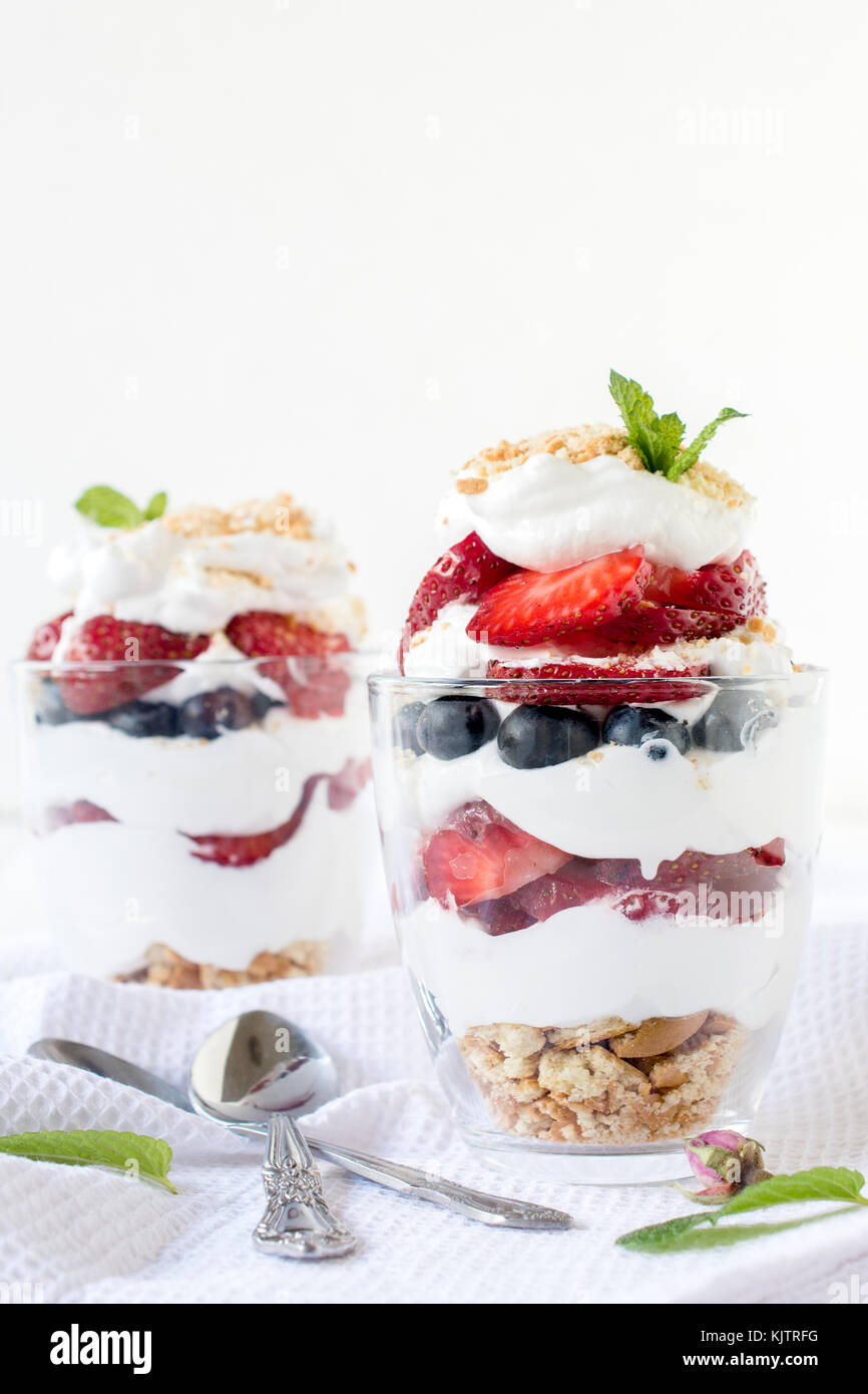 Sweet dessert in glass with biscuit,berry fruit and vanilla cream ...