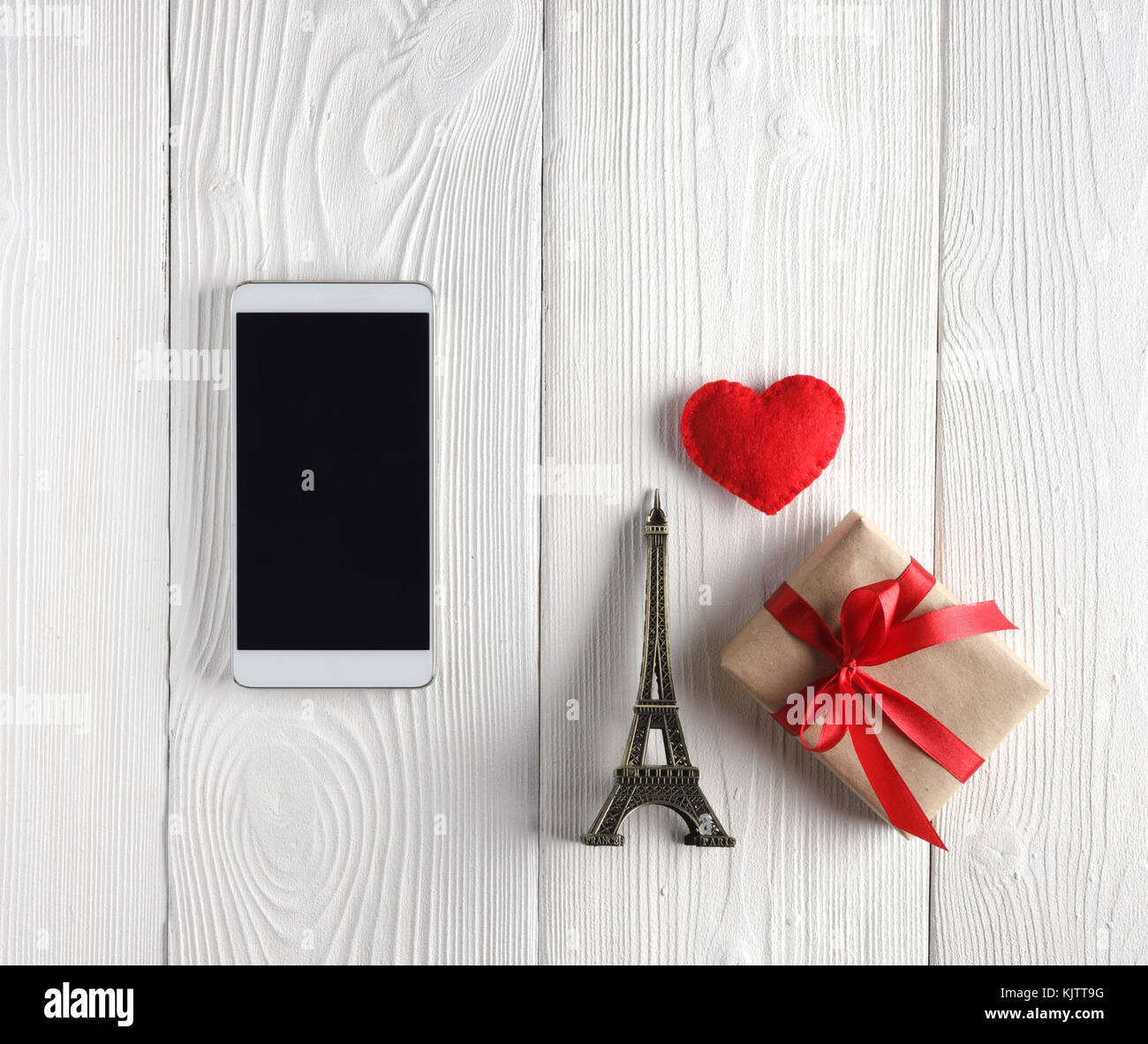 Smartphone and gifts on table Stock Photo - Alamy