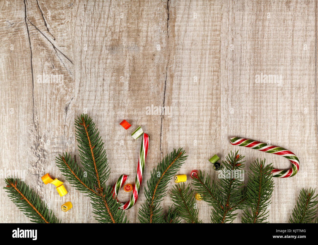 Christmas composition of fir branches, caramel sweets and caramel cane ...