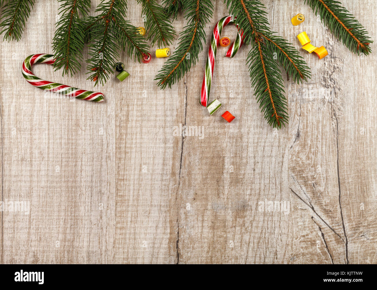 Christmas composition of fir branches, caramel sweets and caramel cane ...