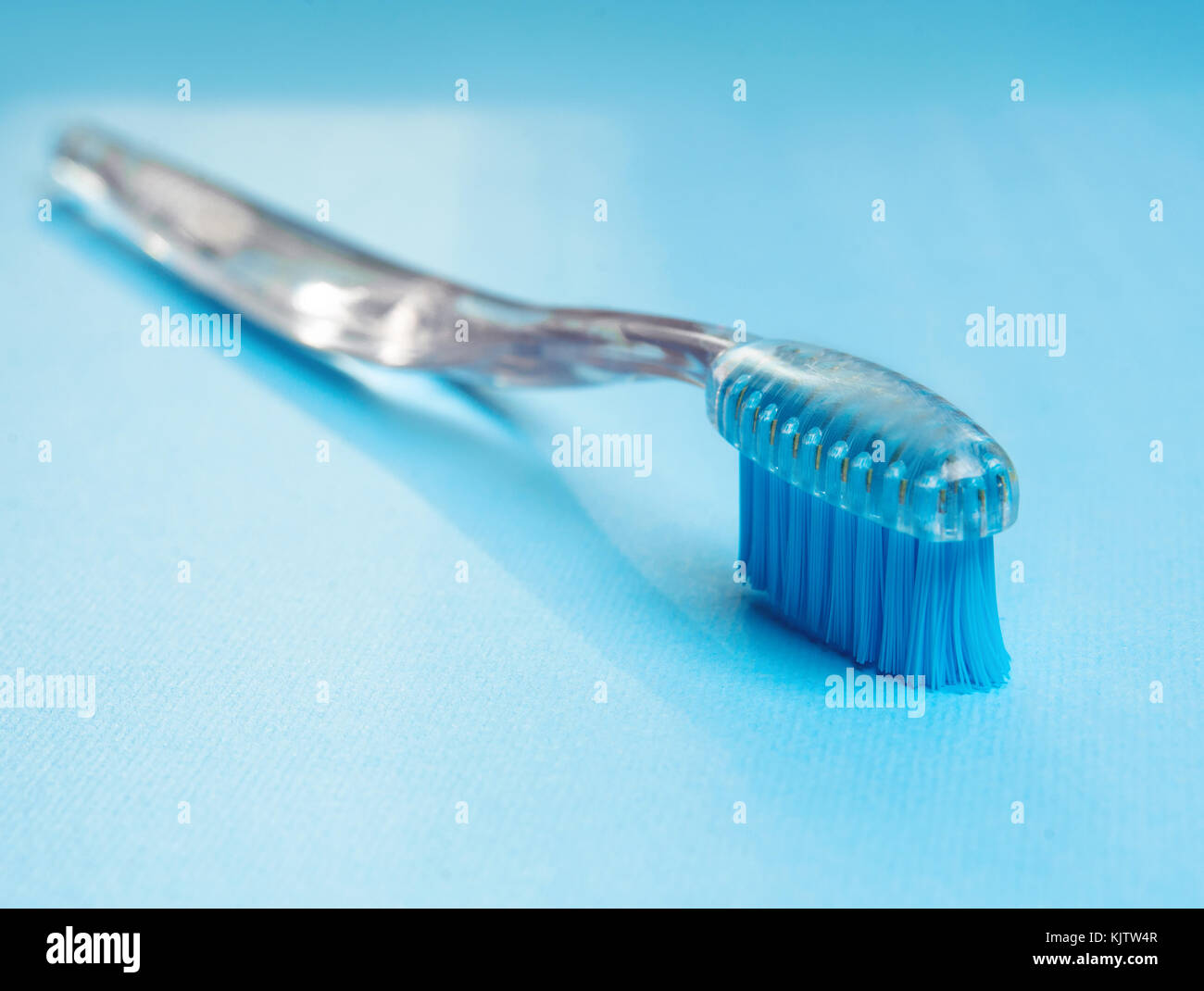 toothbrush on a blue background Stock Photo - Alamy