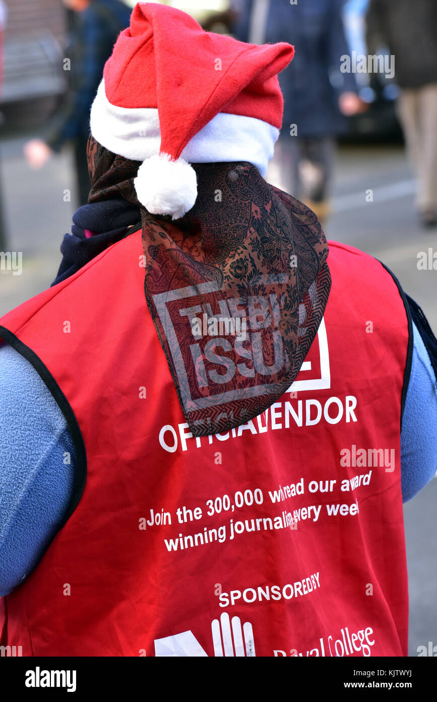 A big issue seller wearing a Santa Claus hat to celebrate Christmas and ...