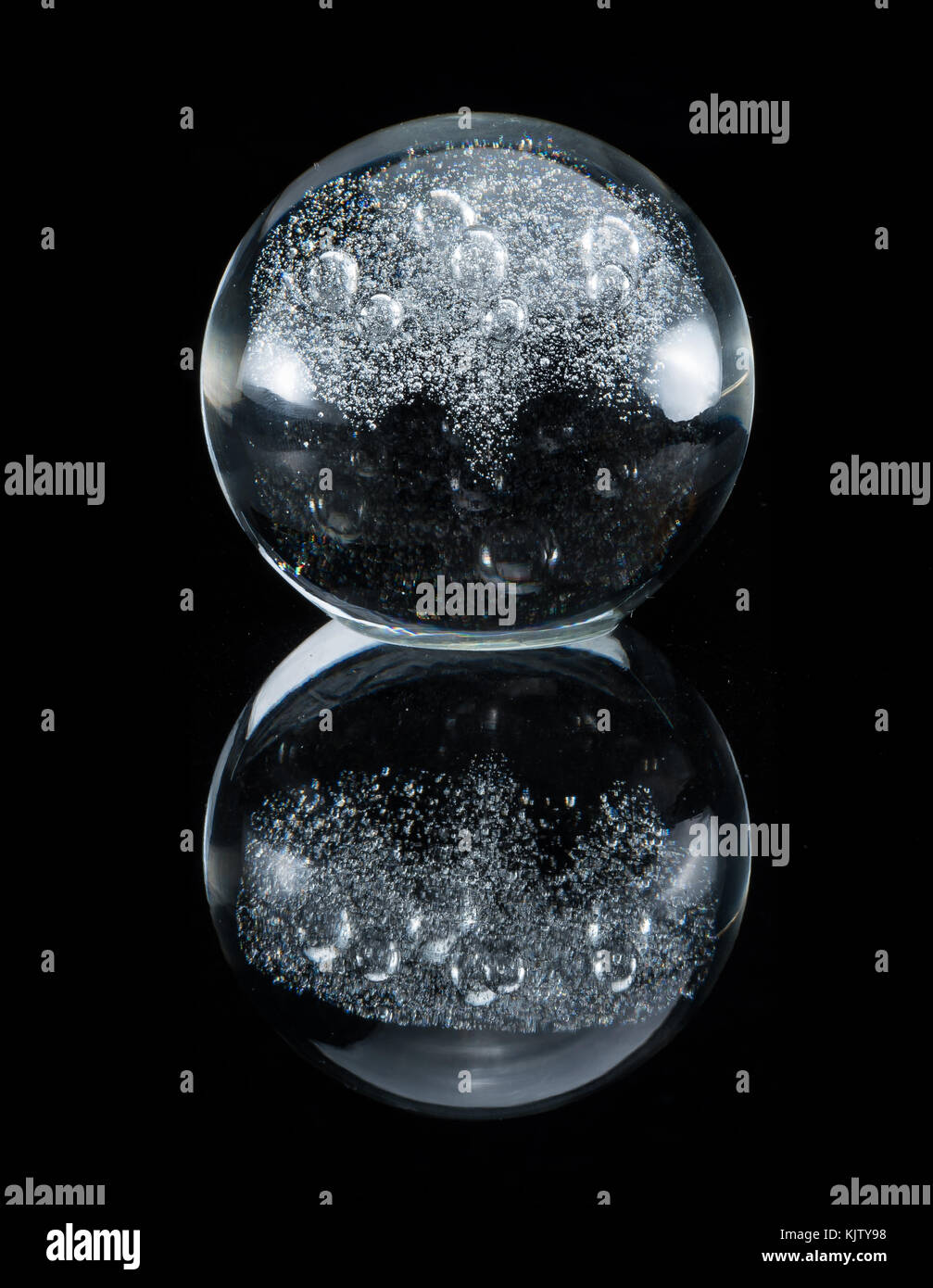 Closeup of a glass sphere standing on a black reflective surface Stock ...