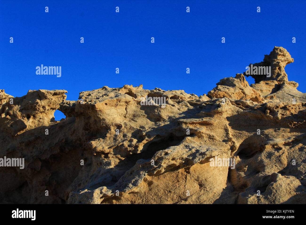 Rock formations on the beach at sunset Stock Photo - Alamy