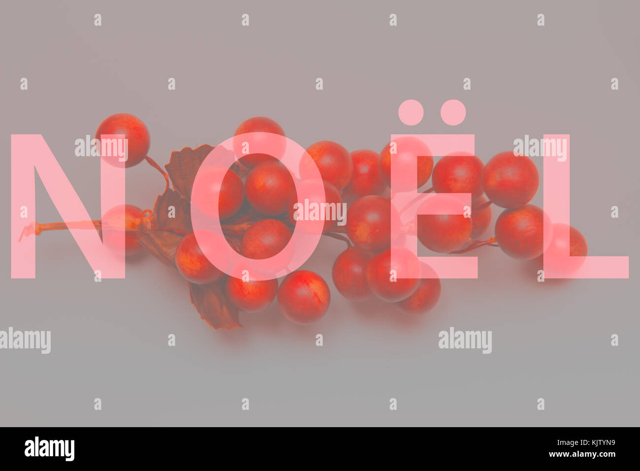 Joyeux Noel text over christmas berry background Stock Photo - Alamy