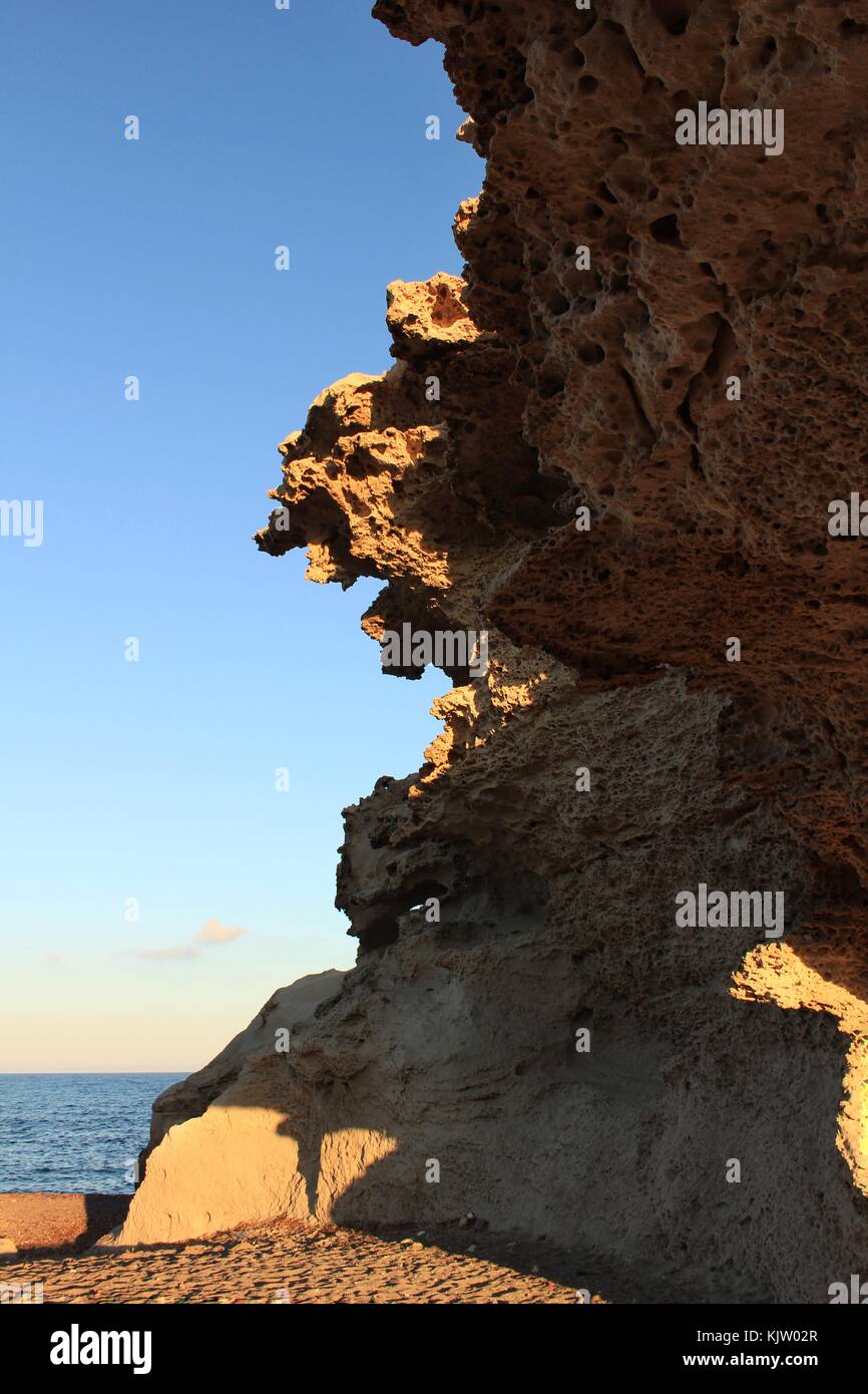 Rock formations on the beach at sunset Stock Photo - Alamy
