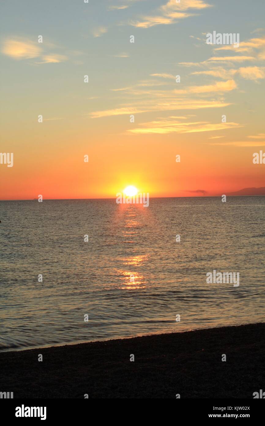 Sunset on the beach Stock Photo - Alamy