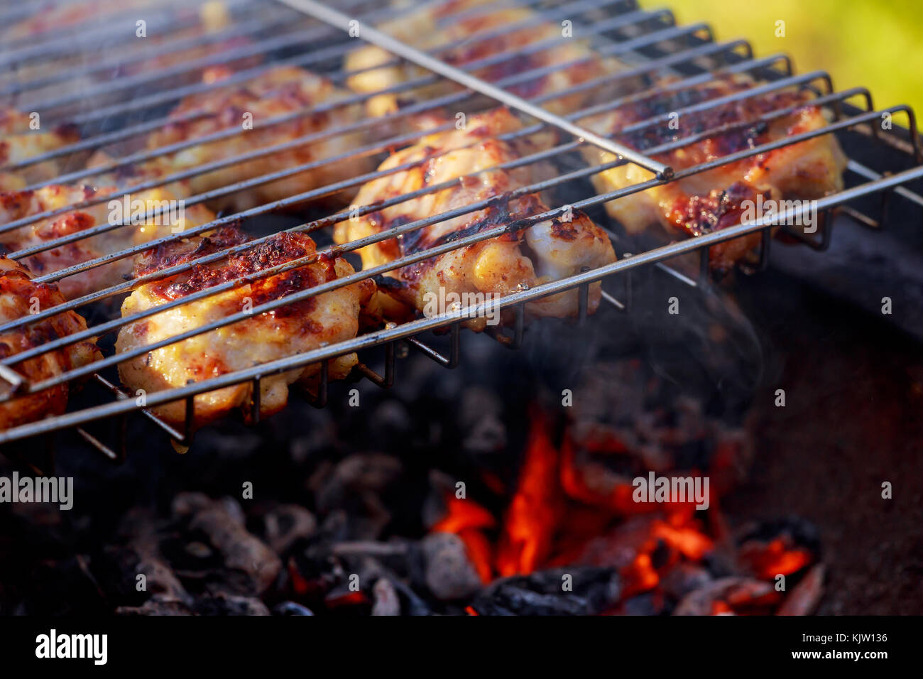 Grilled chicken leg over flames on a barbecue. chicken on the grill ...