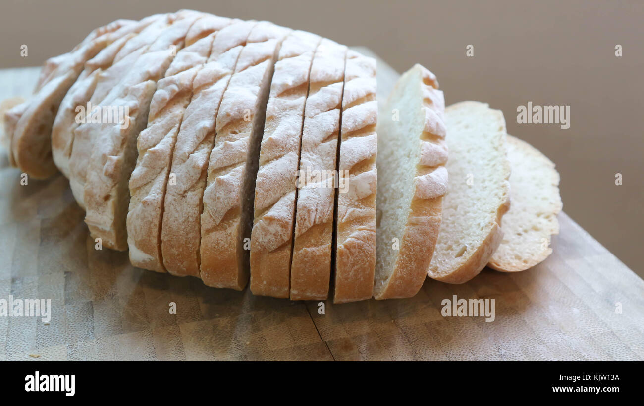 sliced baguette or sliced bread on the block Stock Photo - Alamy