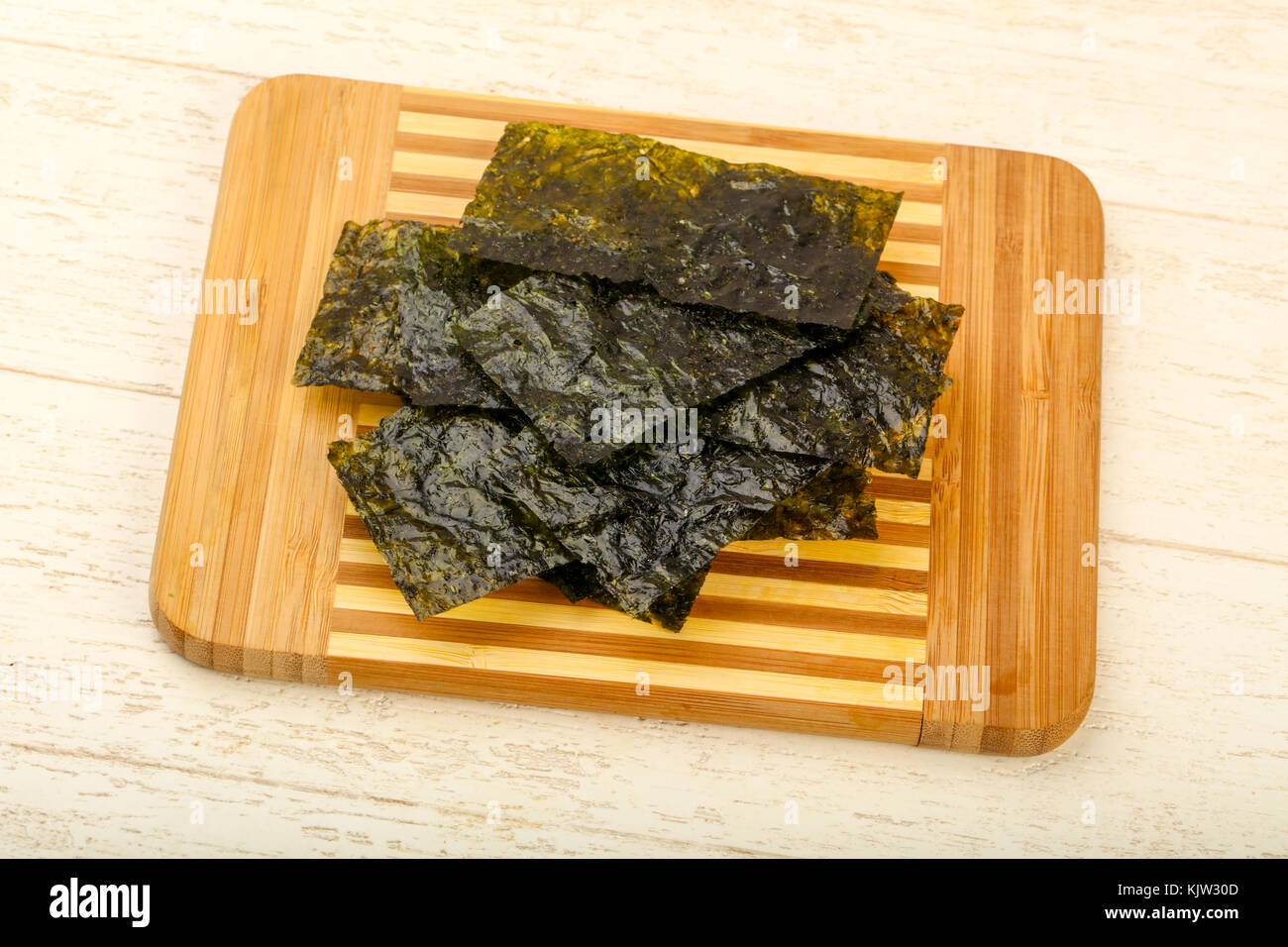 Crispy Nori sheets chips over wooden background Stock Photo - Alamy