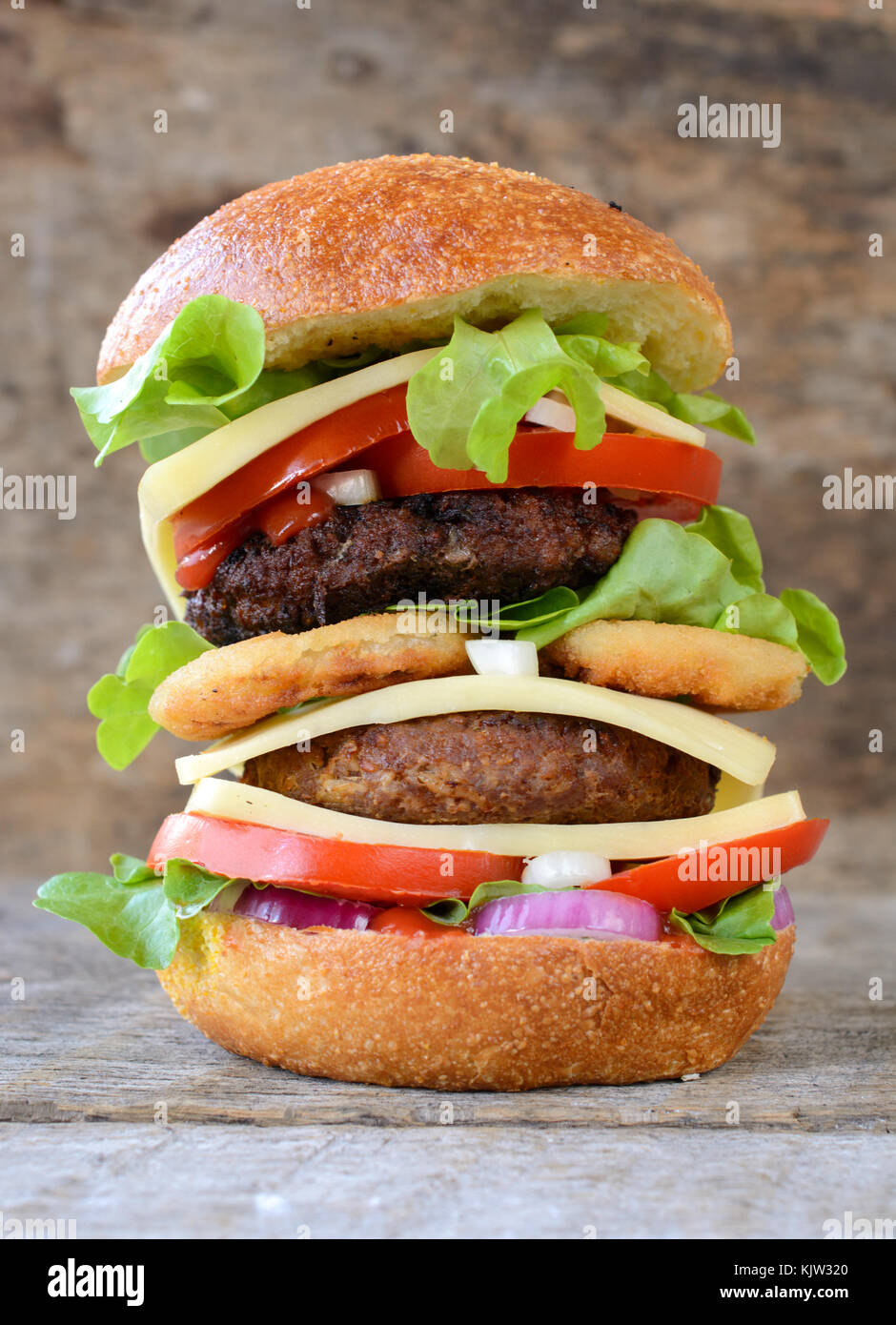 Tasty double beef burger on the wooden background Stock Photo - Alamy