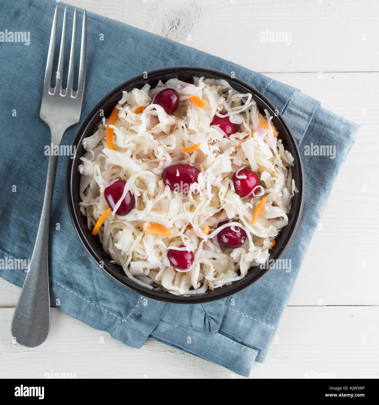 Traditional russian appetizer sauerkraut with cranberry and carrot in ...