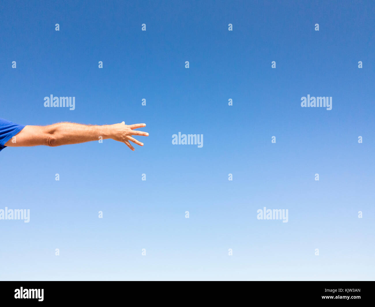 Open hand against blue sky Stock Photo - Alamy
