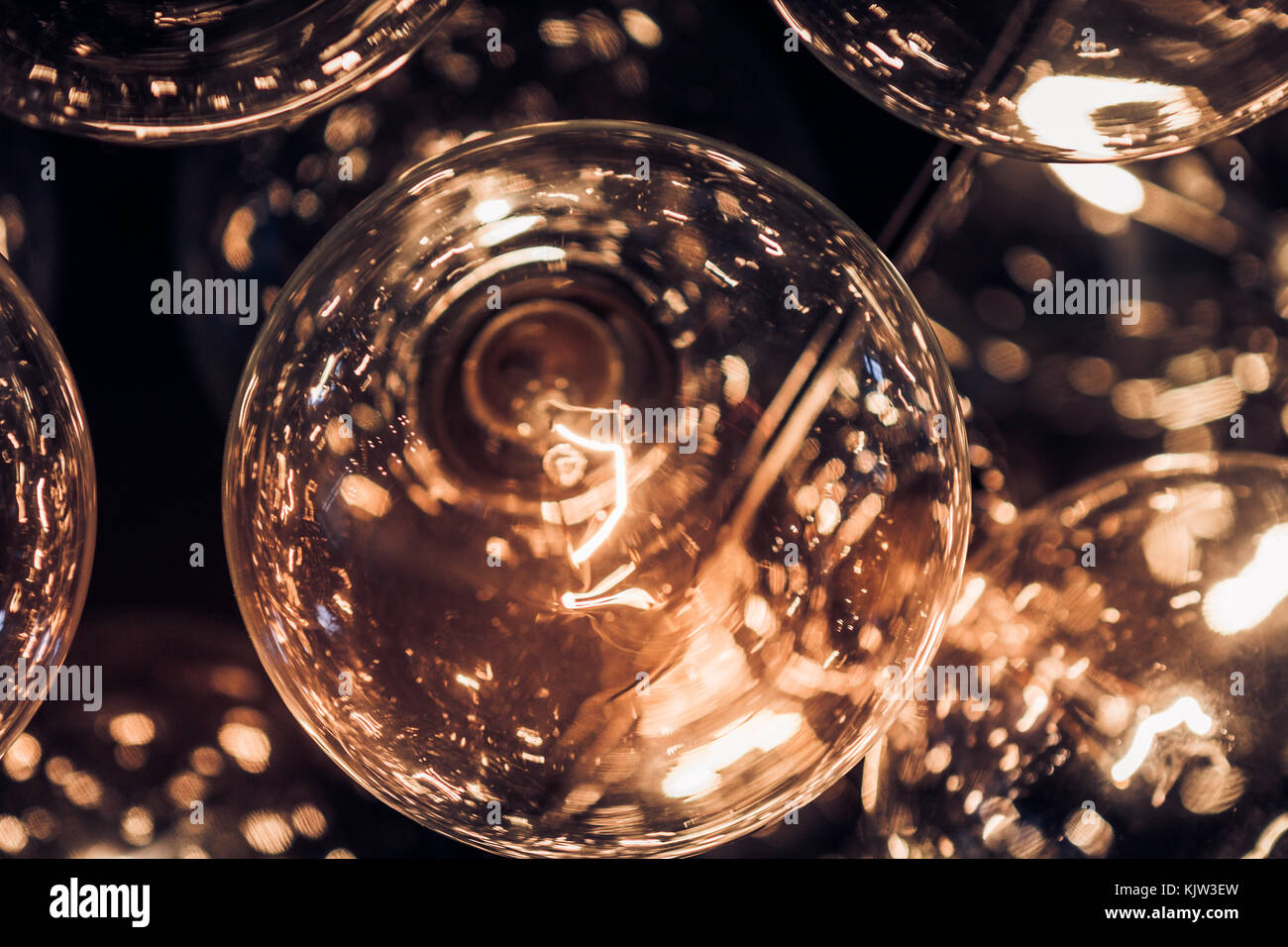 A collection of illuminated light bulbs mounted on the wall Stock Photo ...