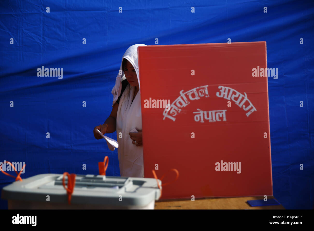 Phidim, Nepal. 26th Nov, 2017. A woman steps out from the ballot box ...