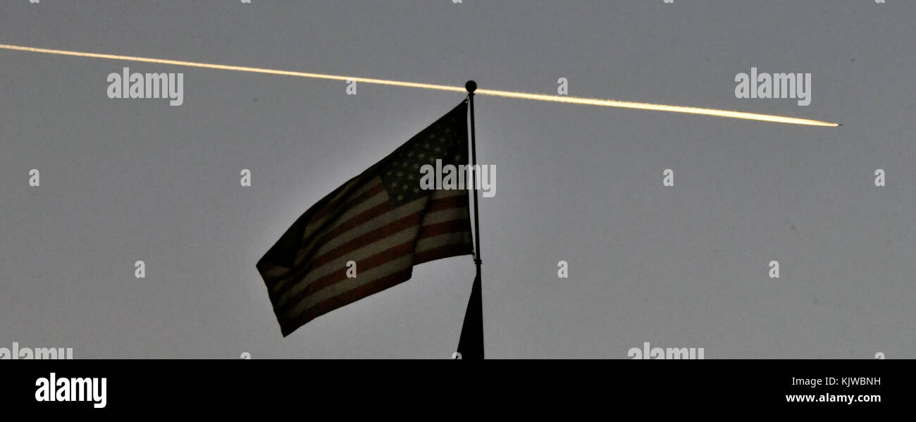 Nov 21-24, 2017. Glamis CA. A jet makes a flyby over the american flag ...