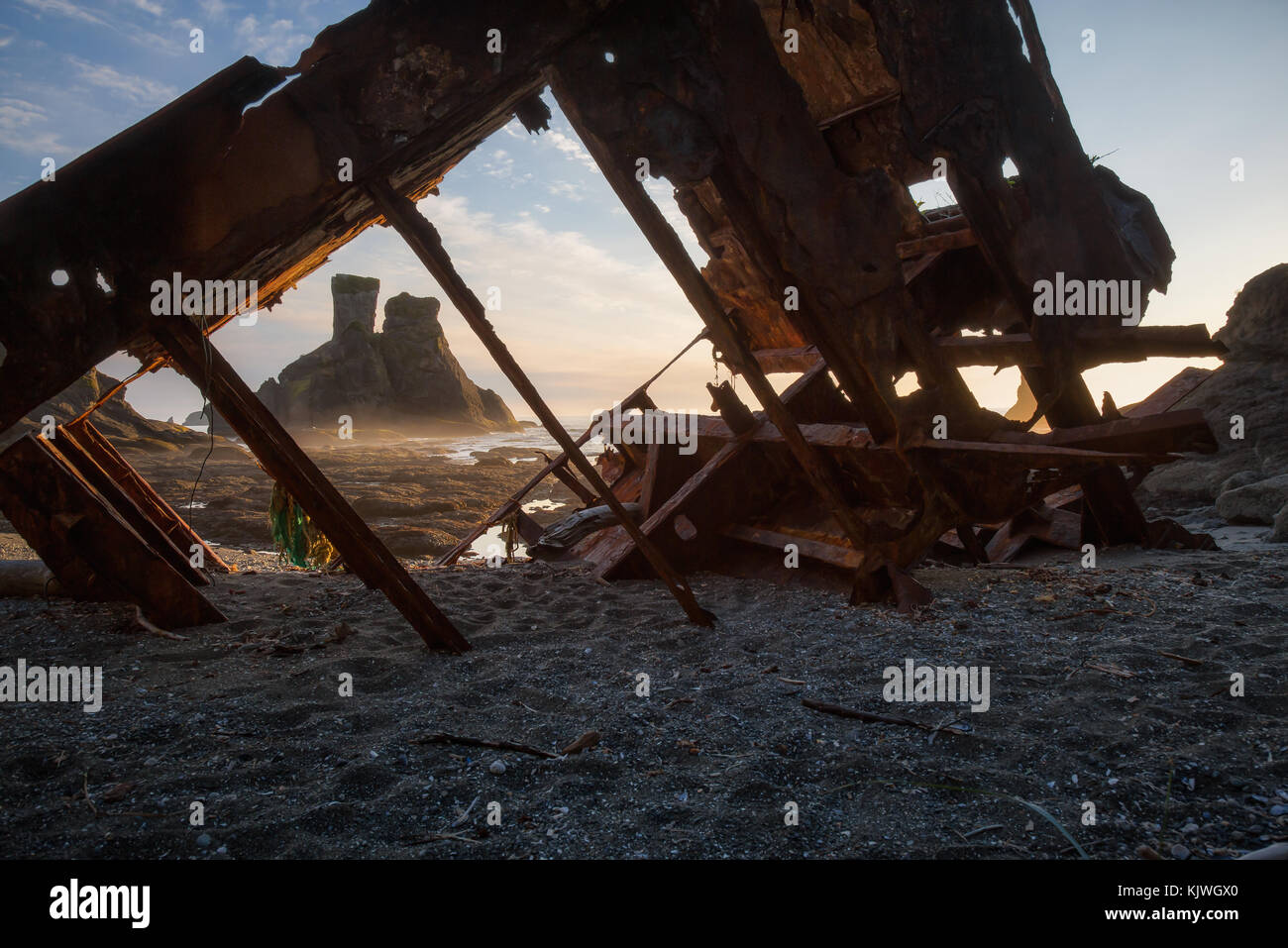 Rusty ship wreck at the beach with rugged rock formation. Taken in Shi ...
