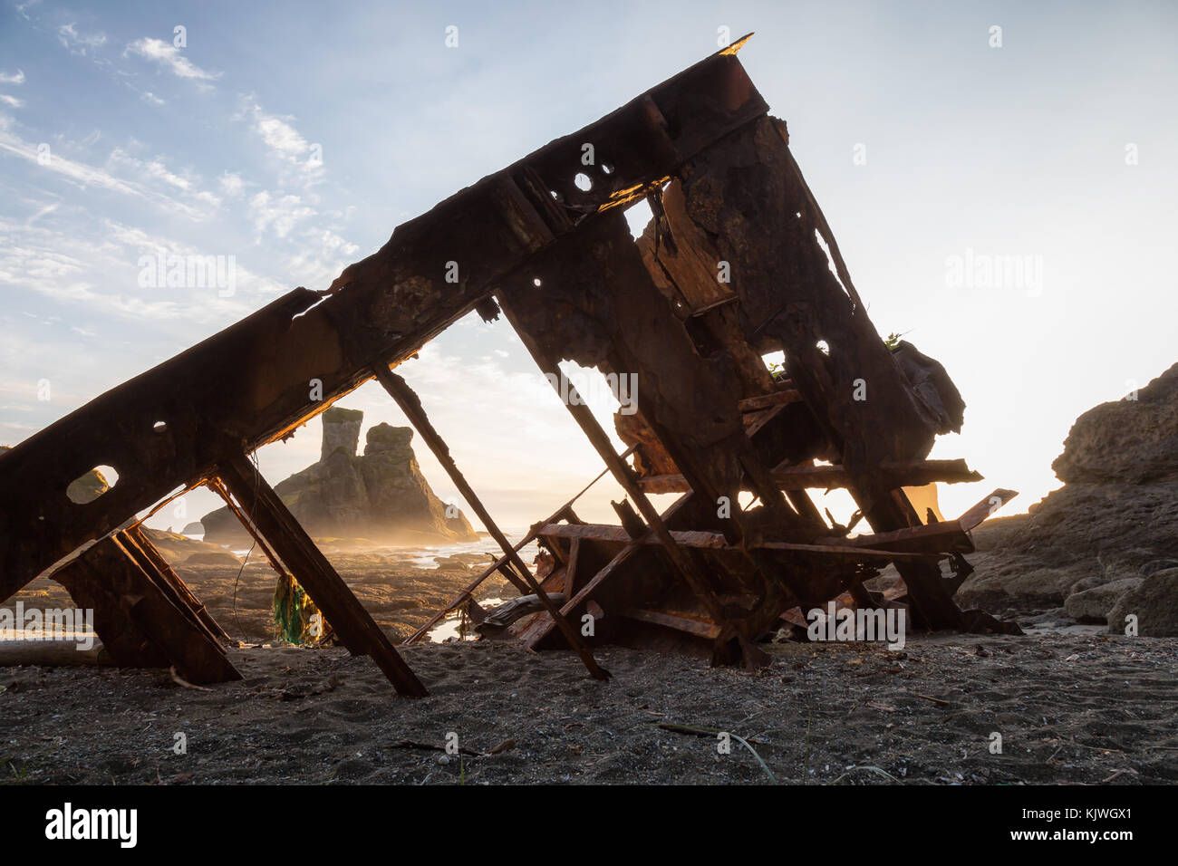 Rusty ship wreck at the beach with rugged rock formation. Taken in Shi ...
