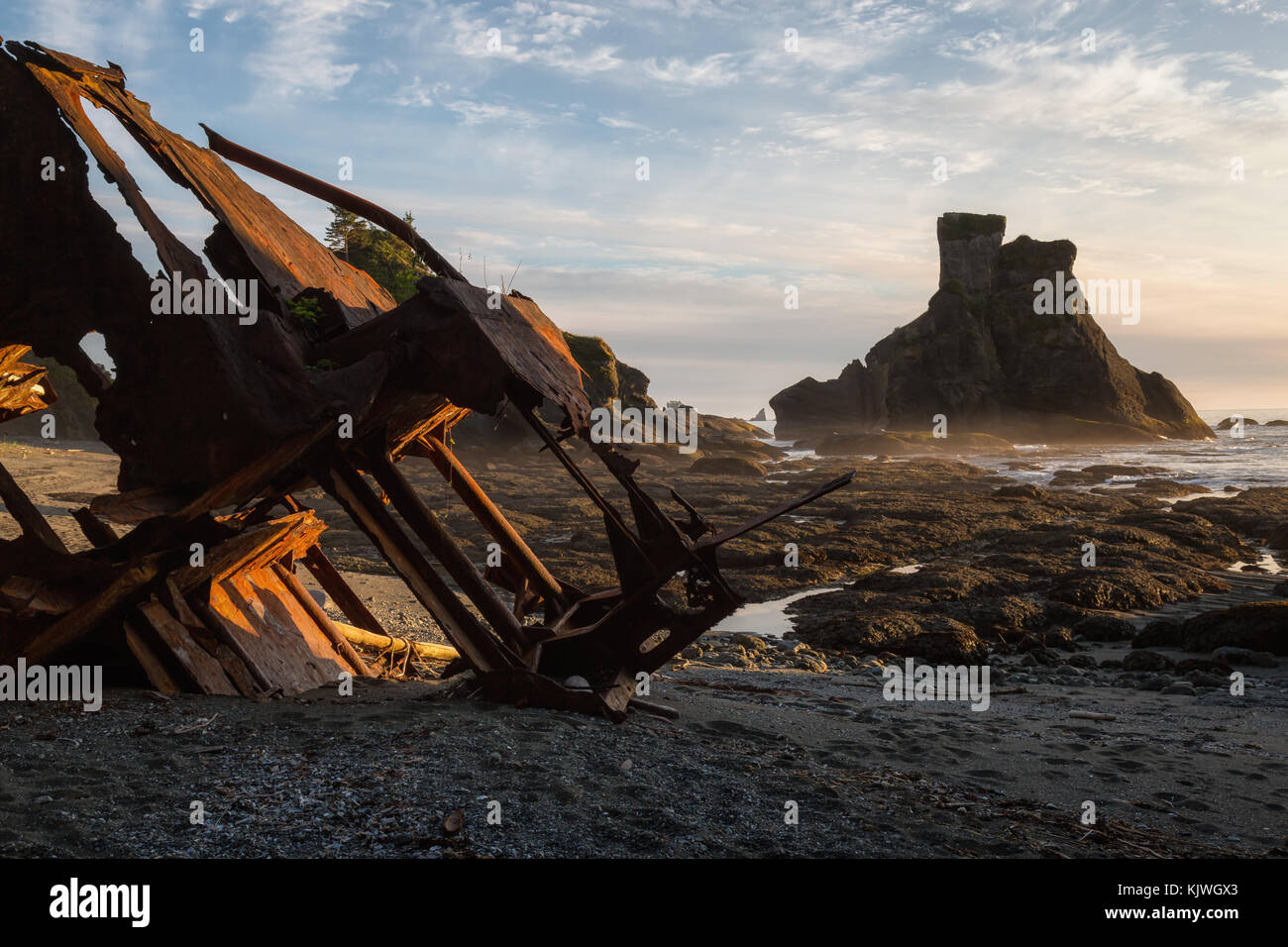 Rusty ship wreck at the beach with rugged rock formation. Taken in Shi ...