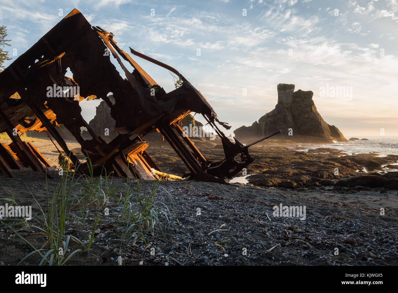 Rusty ship wreck at the beach with rugged rock formation. Taken in Shi ...
