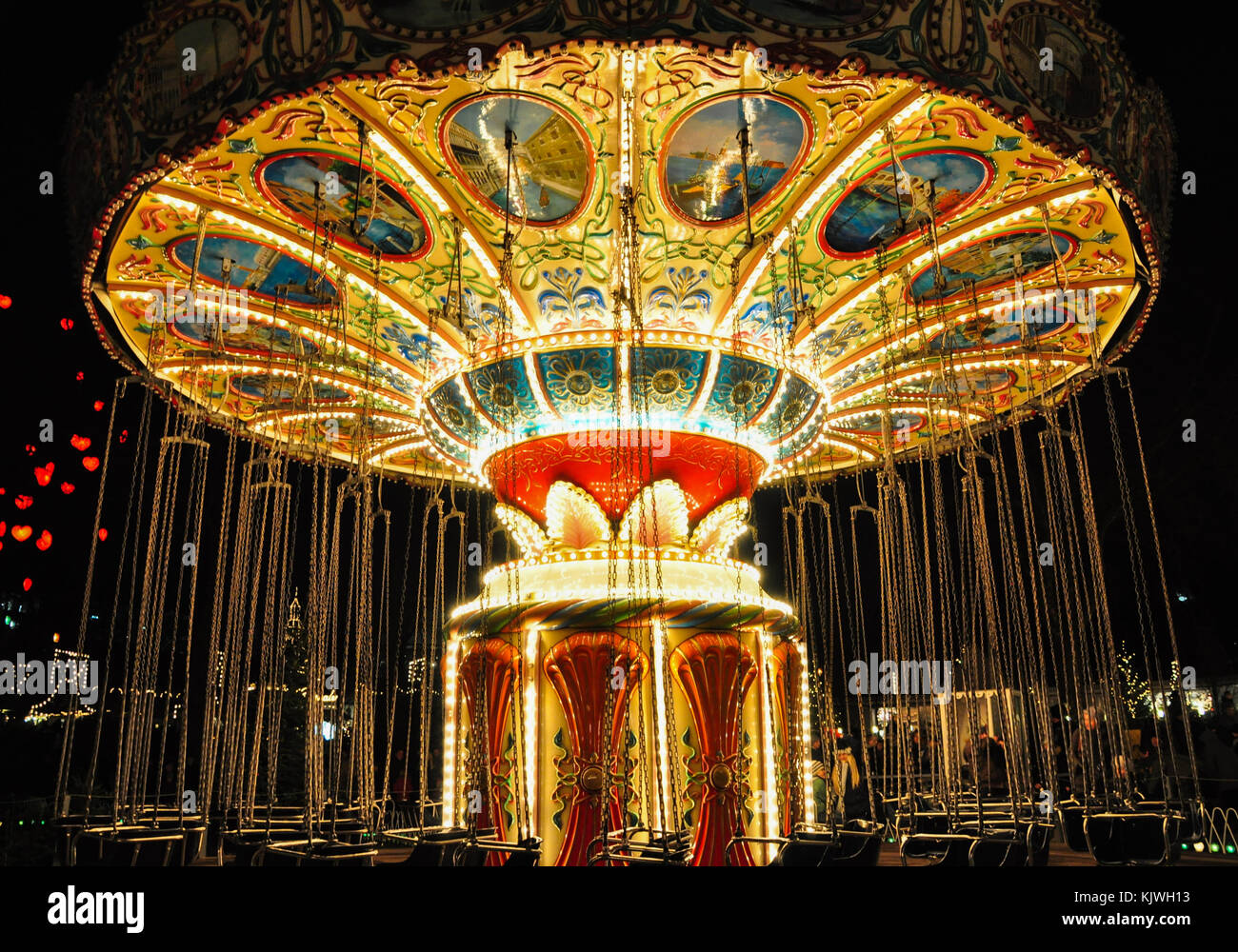 Chain carousel with bright lights and vibrant colors in Copenhagen ...