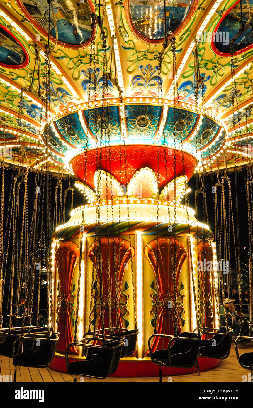 Chain carousel with bright lights and vibrant colors in Copenhagen ...