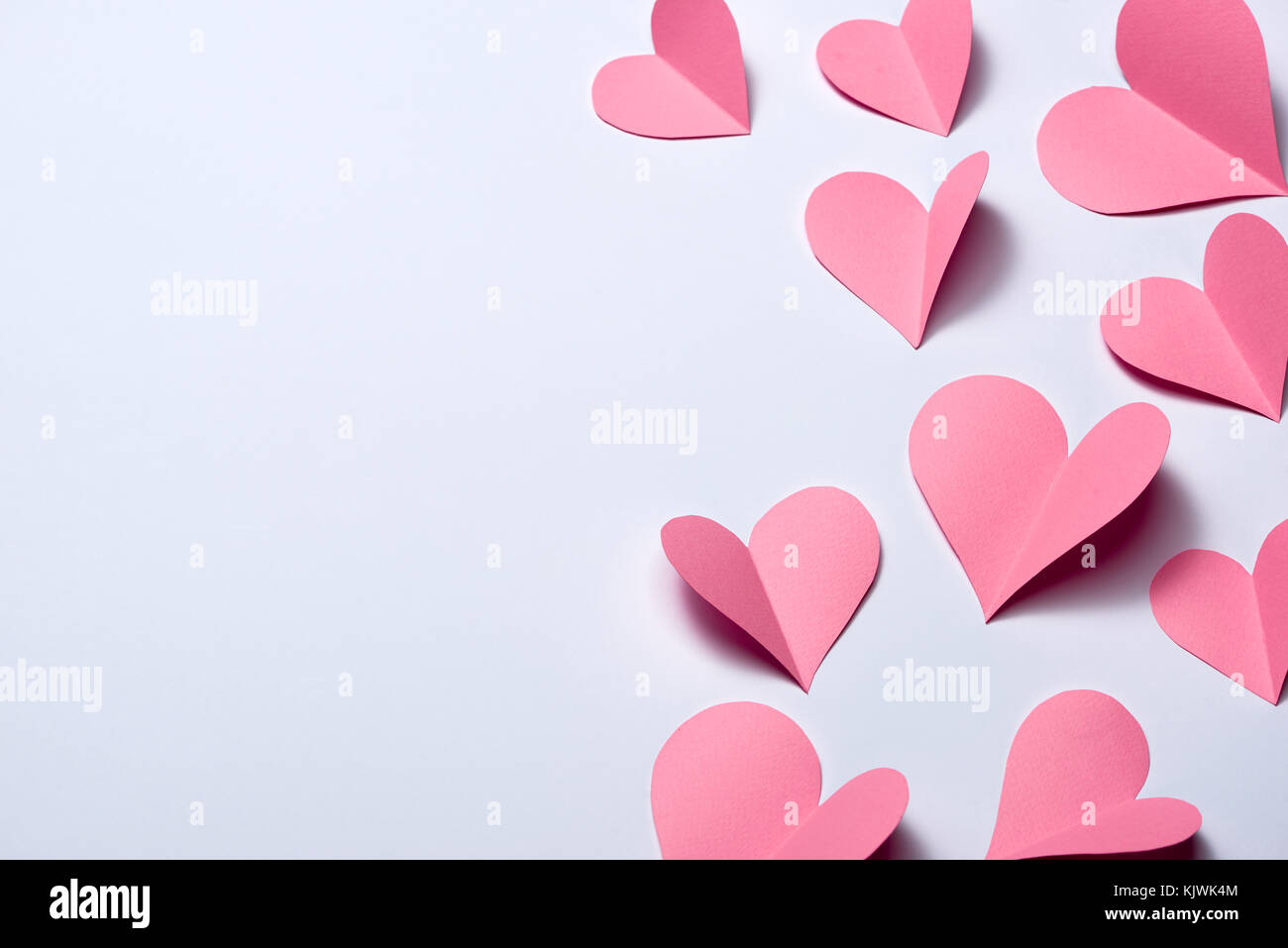 Beautiful pink paper hearts on white paper background Stock Photo - Alamy
