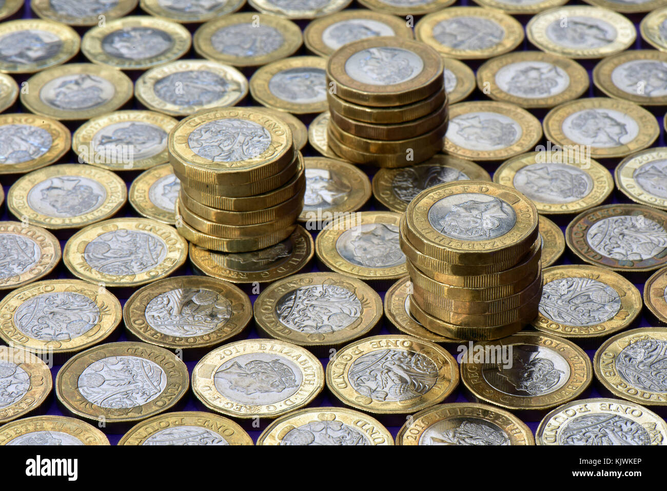 a large number or lots of one pound gold and silver coins lying flat ...