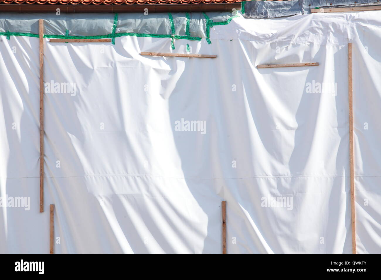 white tarpaulin on a house wall, construction site Stock Photo - Alamy