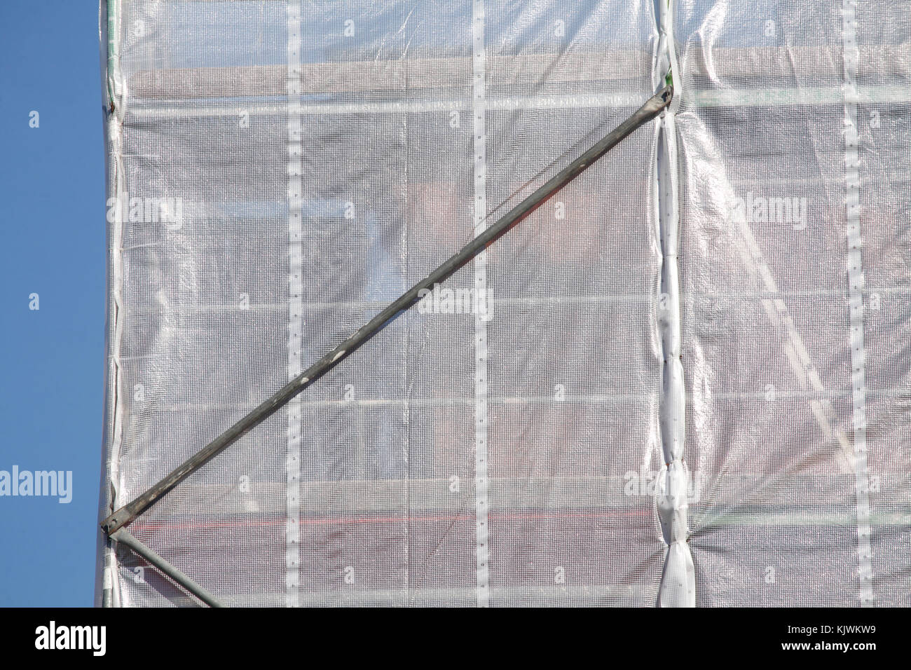 scaffold and Cover tarpaulin on a Construction Site Stock Photo - Alamy