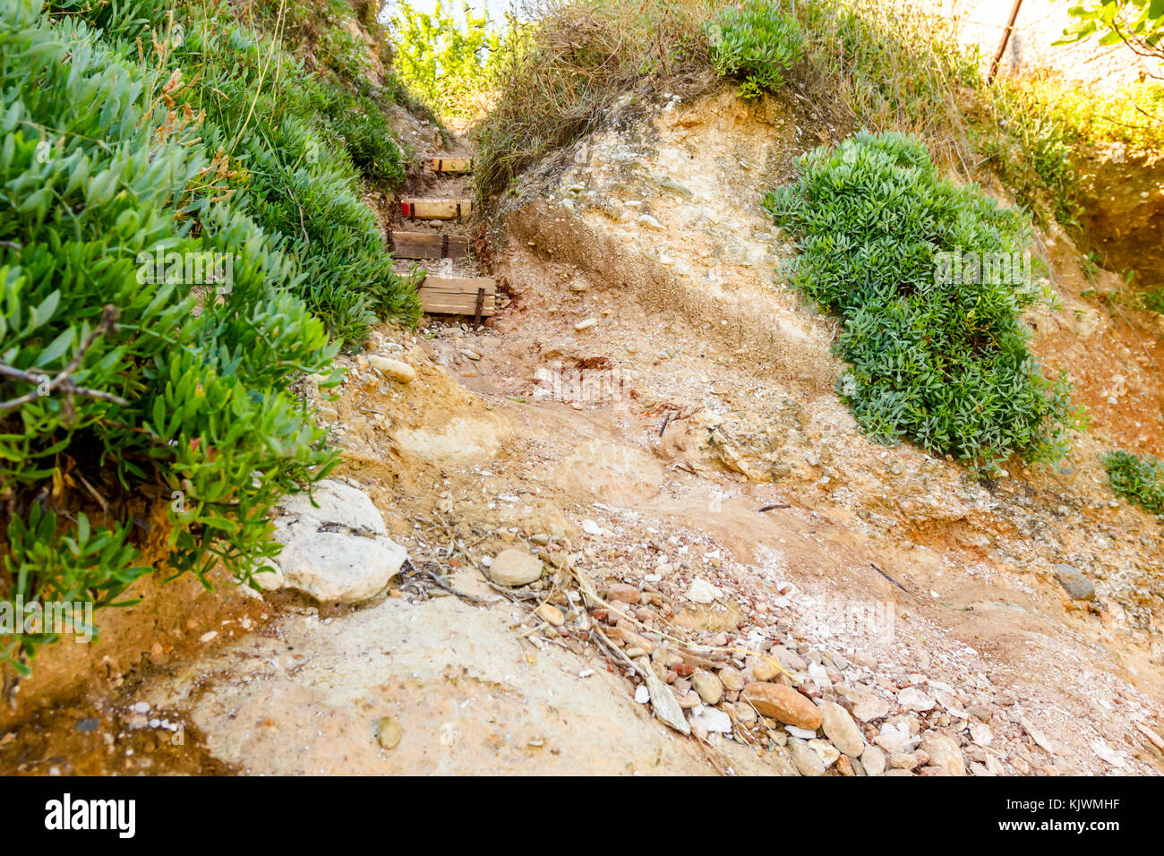Narrow passage through corridor in rock with carved stairs Stock Photo ...