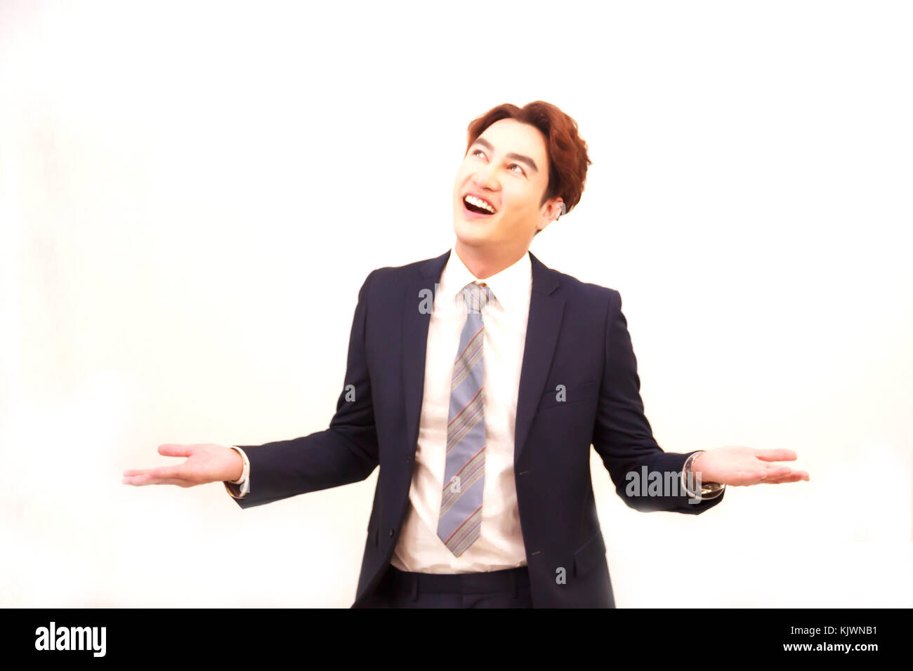 A Businessman smiles with open hands posture, looking upwards, inviting ...