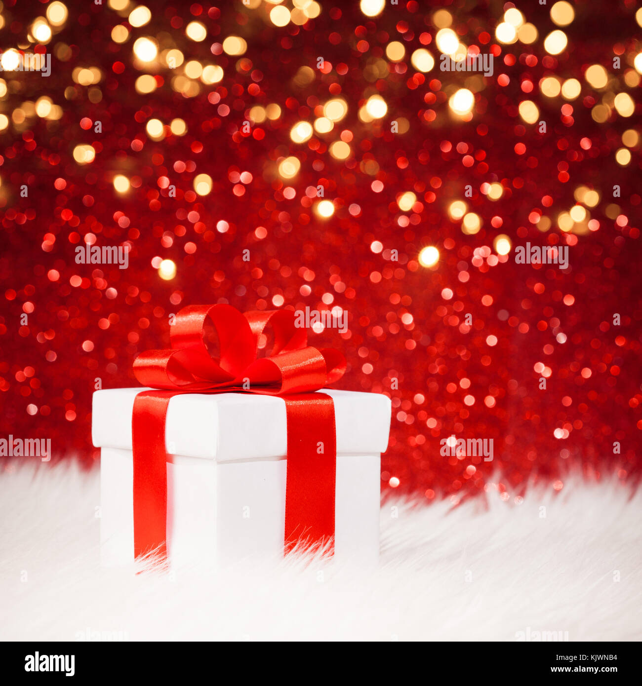 christmas gift with red bow Stock Photo - Alamy