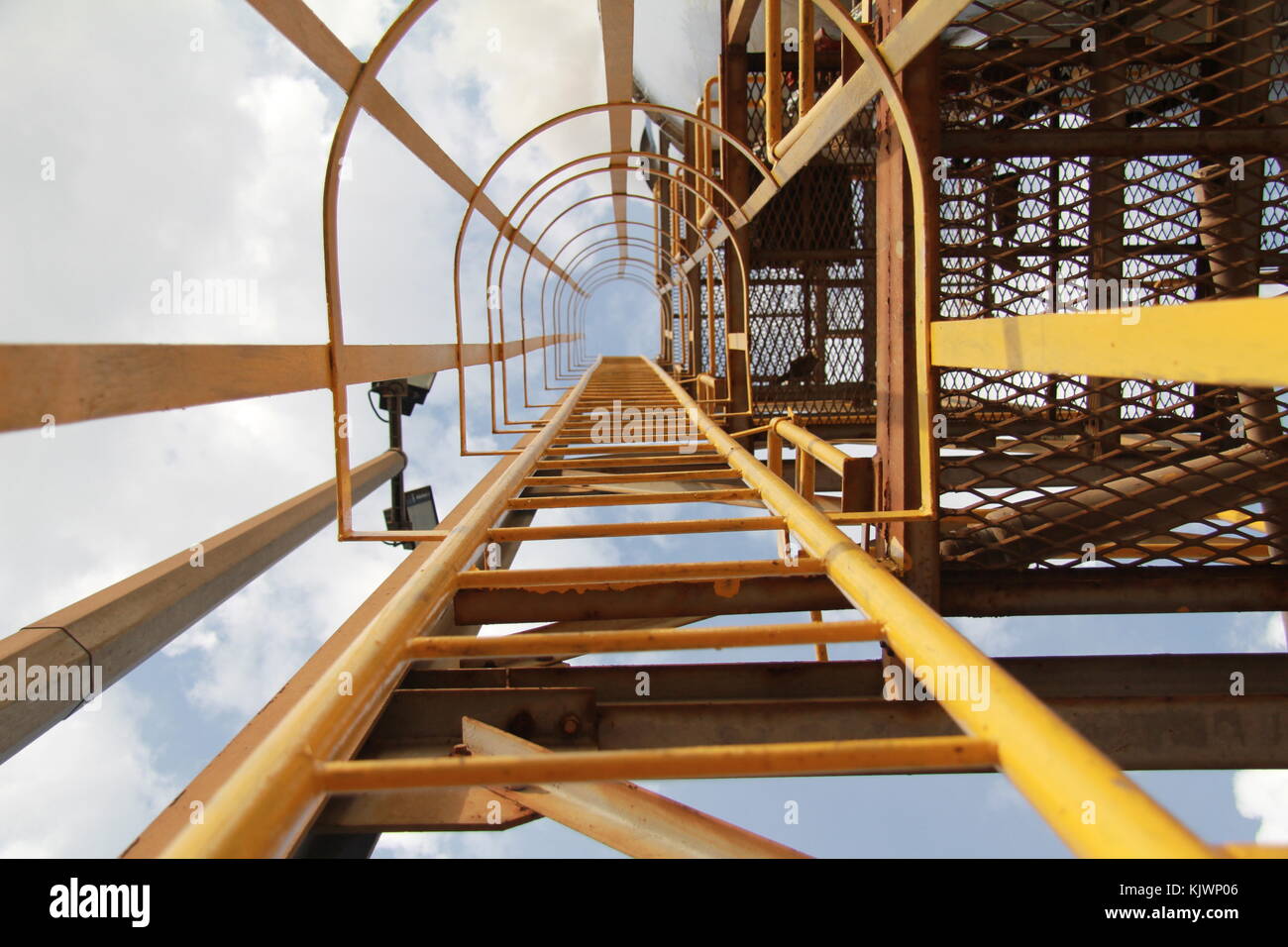 Industrial Yellow Ladder under the sky Stock Photo - Alamy