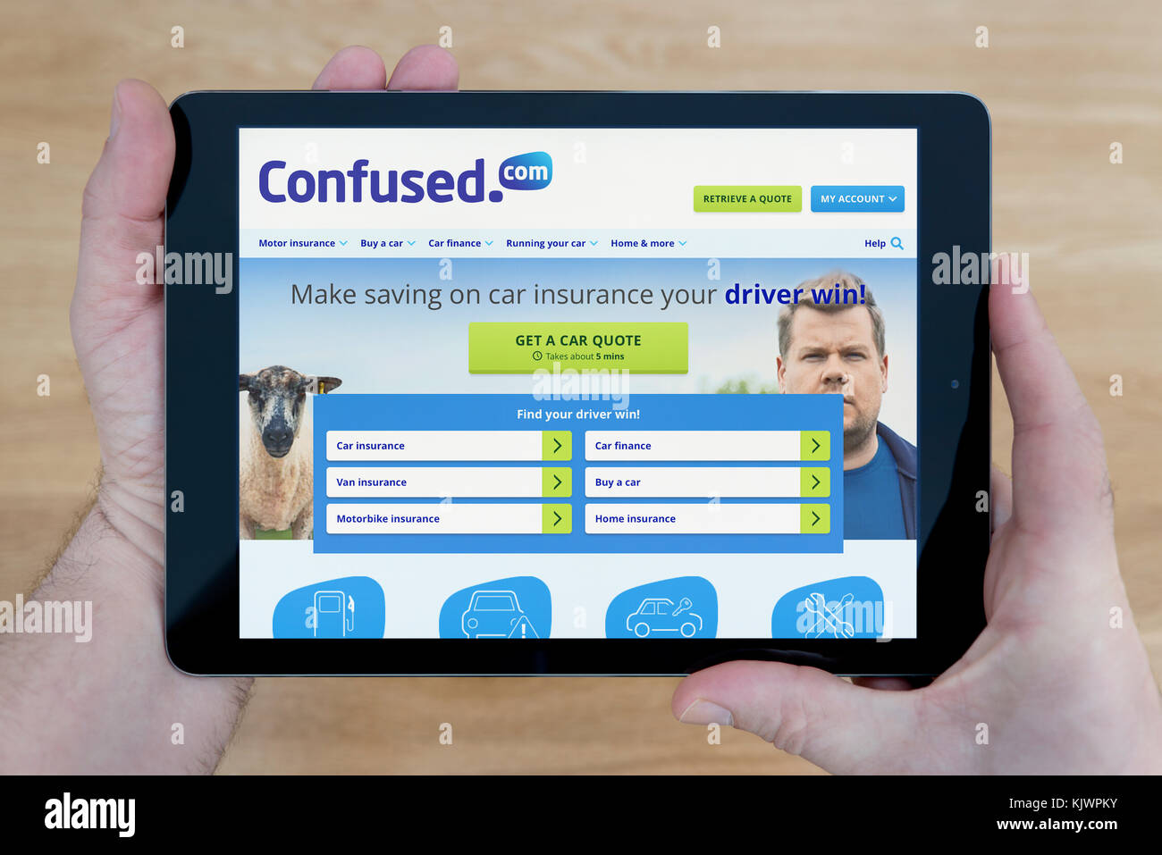 A man looks at the confused.com website on his iPad tablet device, shot ...