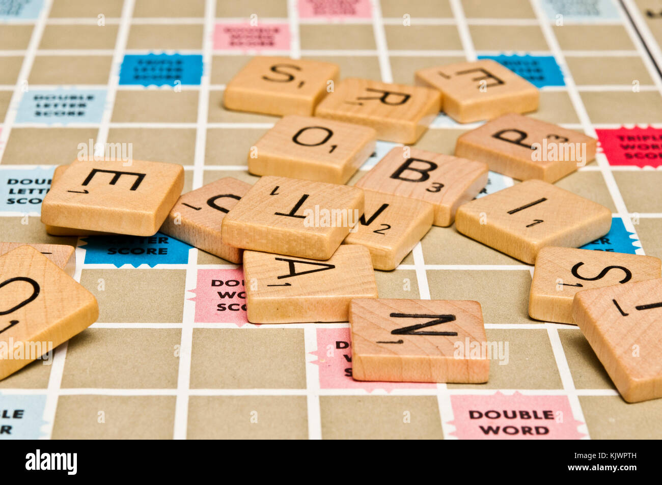 scrabble tiles scattered on the board Stock Photo - Alamy