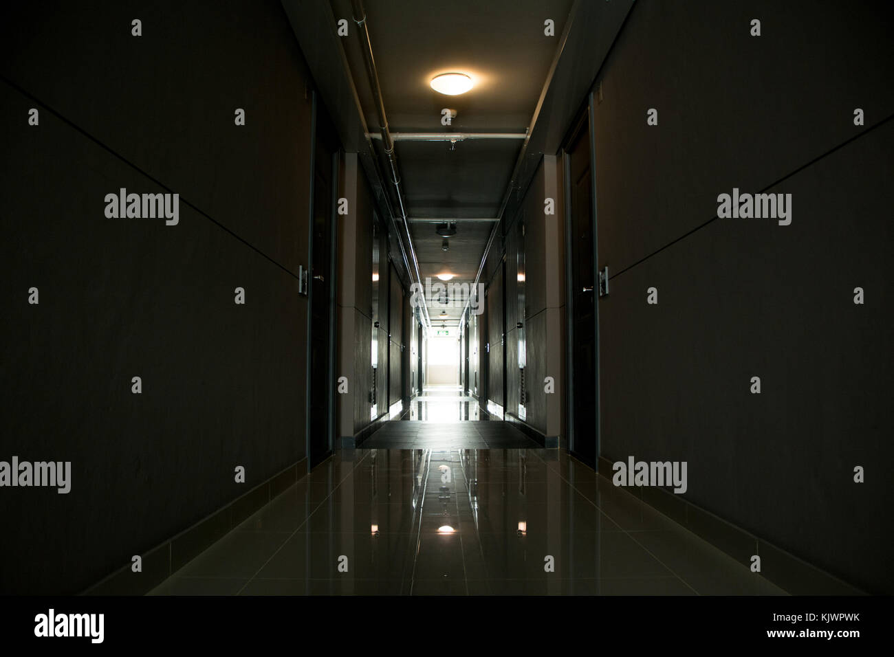 Long corridor in a modern building, light at the end Stock Photo - Alamy