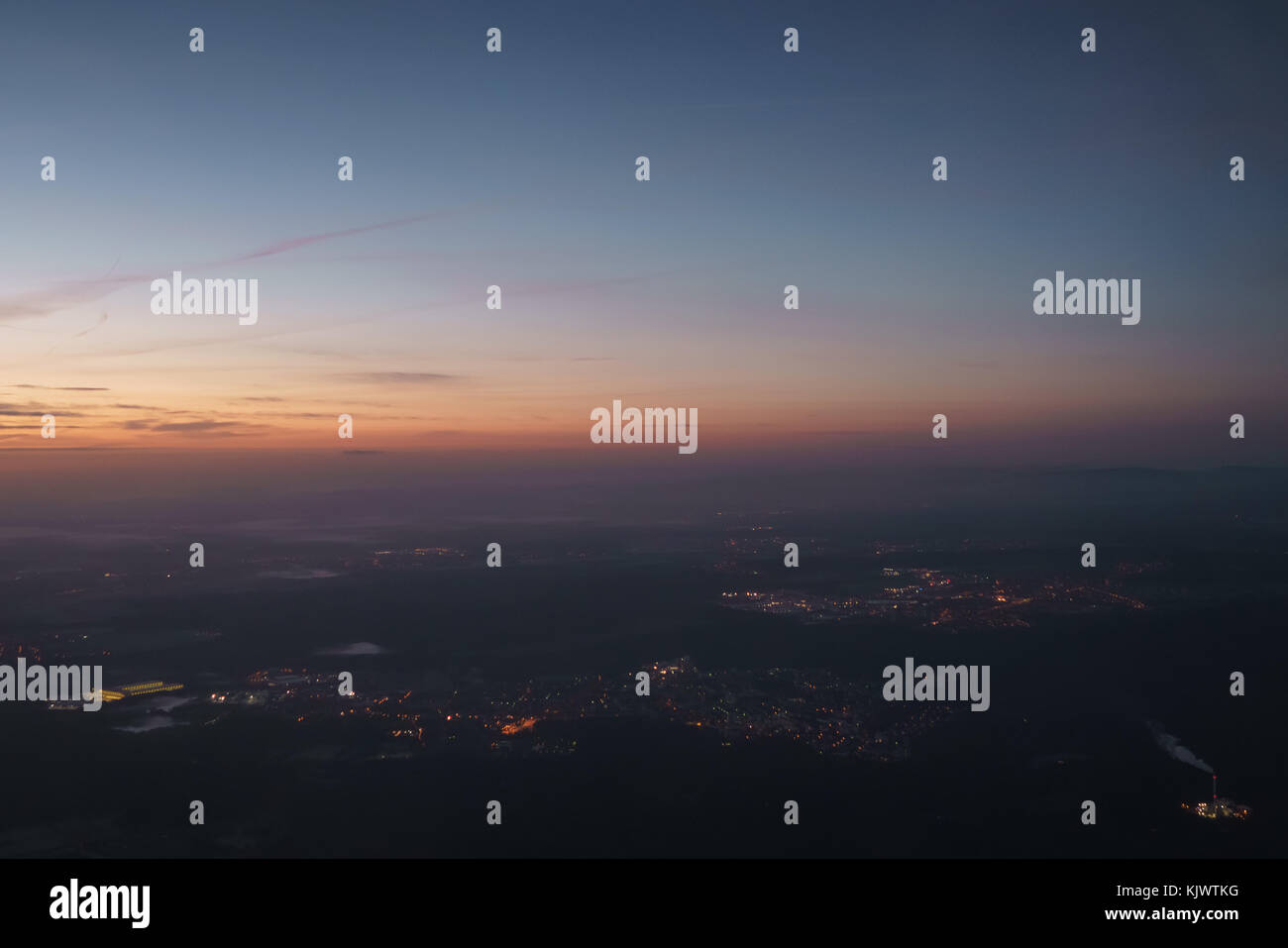 sunrise over city during flight on a plane Stock Photo - Alamy