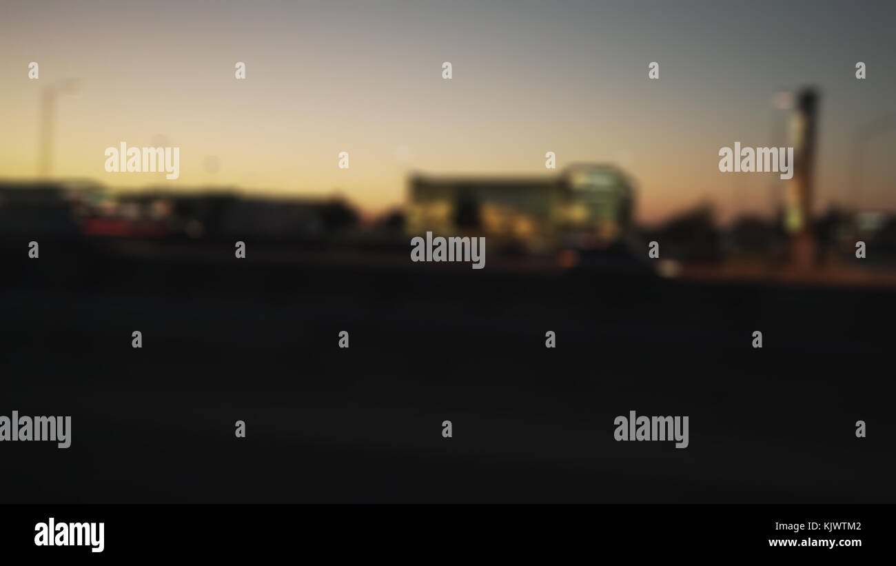 blurred side view from car of small town in sunset Stock Photo - Alamy