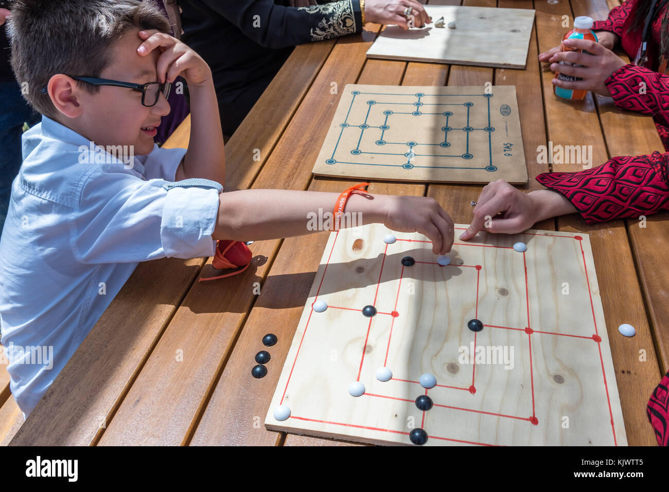 Unidentified children play a traditional Turkish wooden puzzle game ...