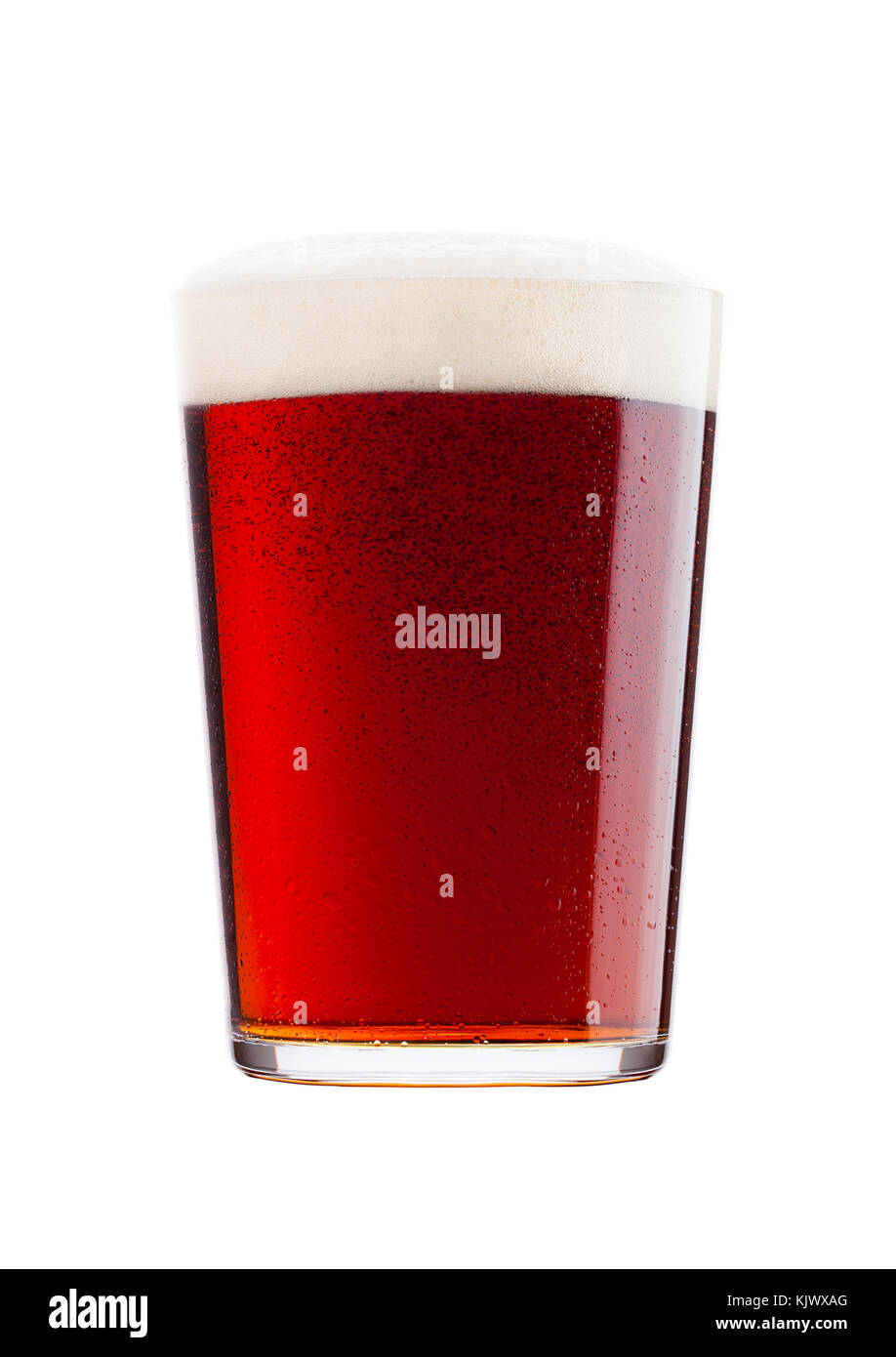 Cold glass of red bitter beer with foam and dew isolated on white ...
