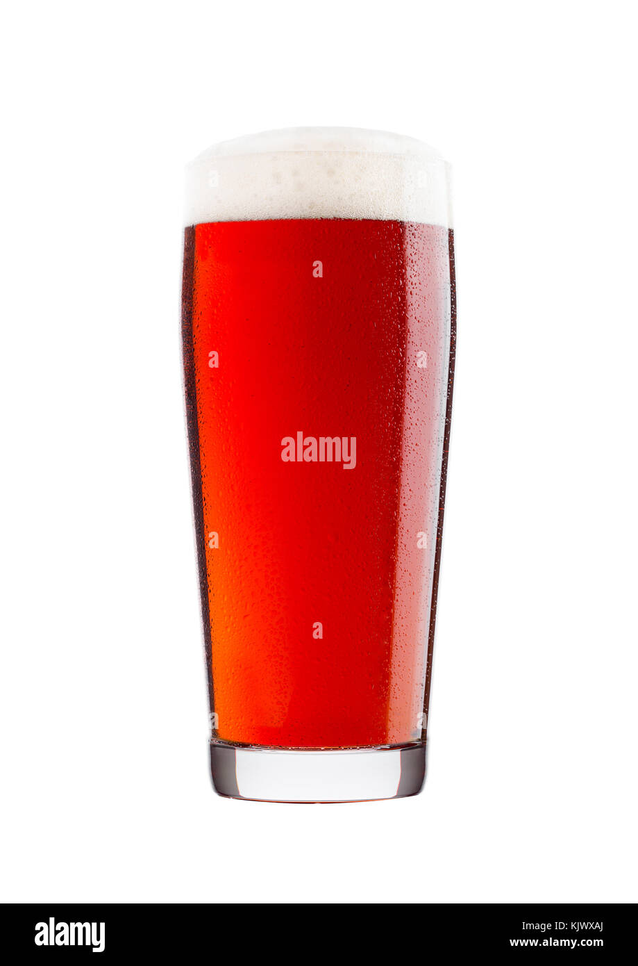 Cold glass of red bitter beer with foam and dew isolated on white ...