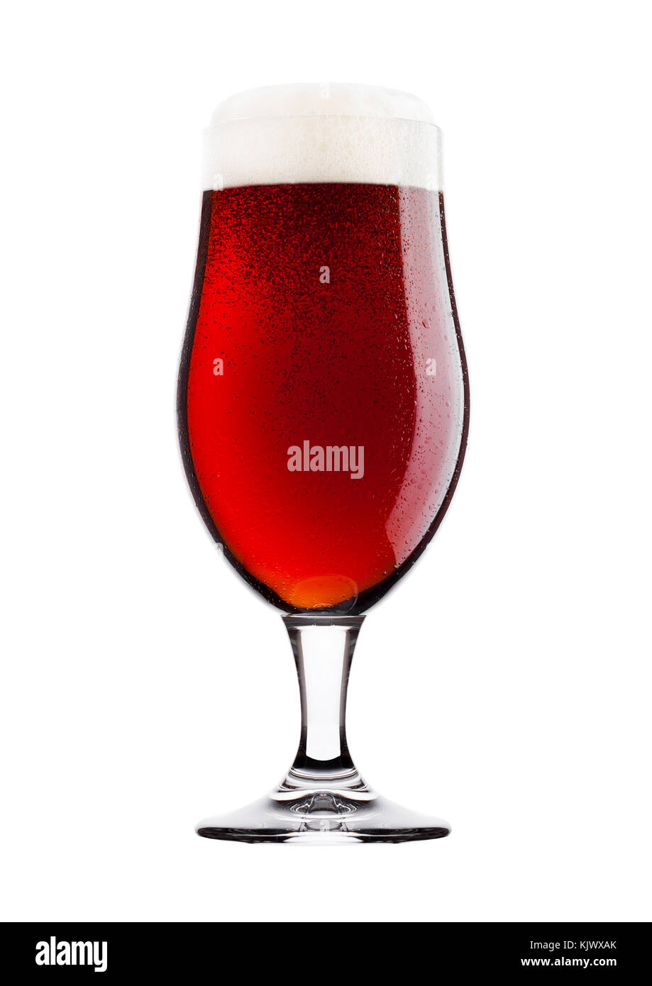 Cold glass of red bitter beer with foam and dew isolated on white ...