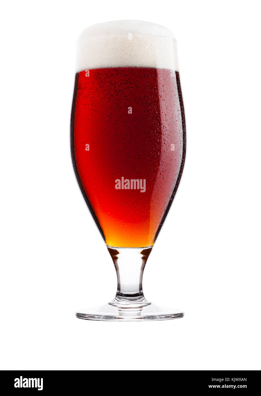 Cold glass of red bitter beer with foam and dew isolated on white ...