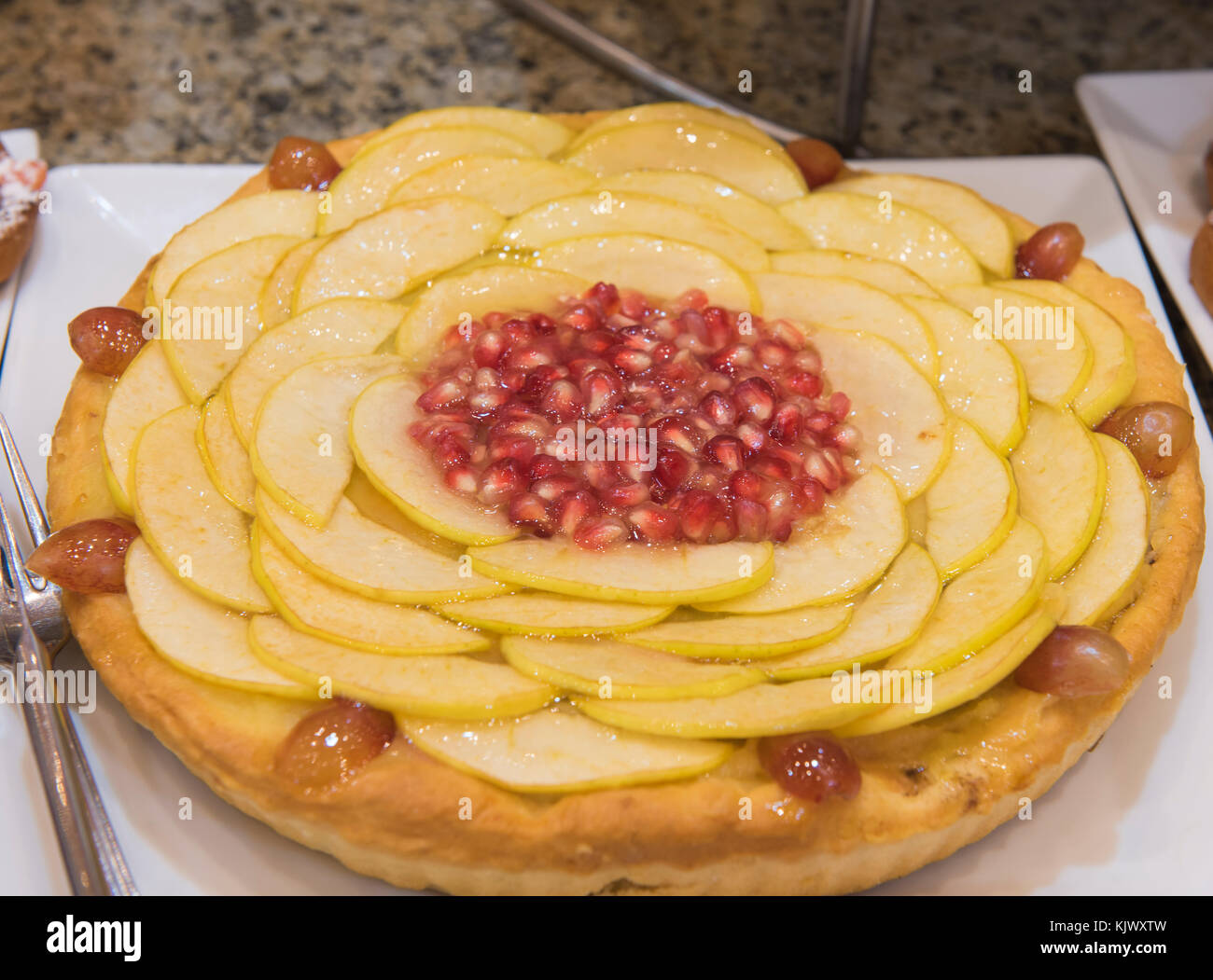 Fruit tart display dessert food at a luxury restaurant buffet bar area ...