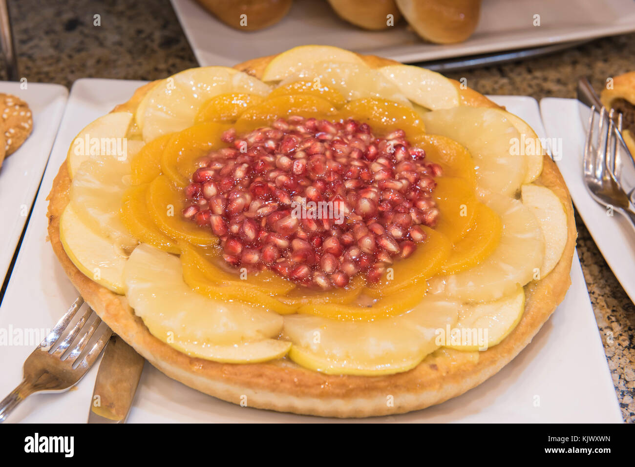 Fruit tart display dessert food at a luxury restaurant buffet bar area ...