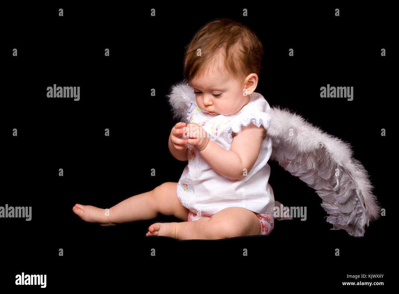 six month baby angel over black background Stock Photo - Alamy